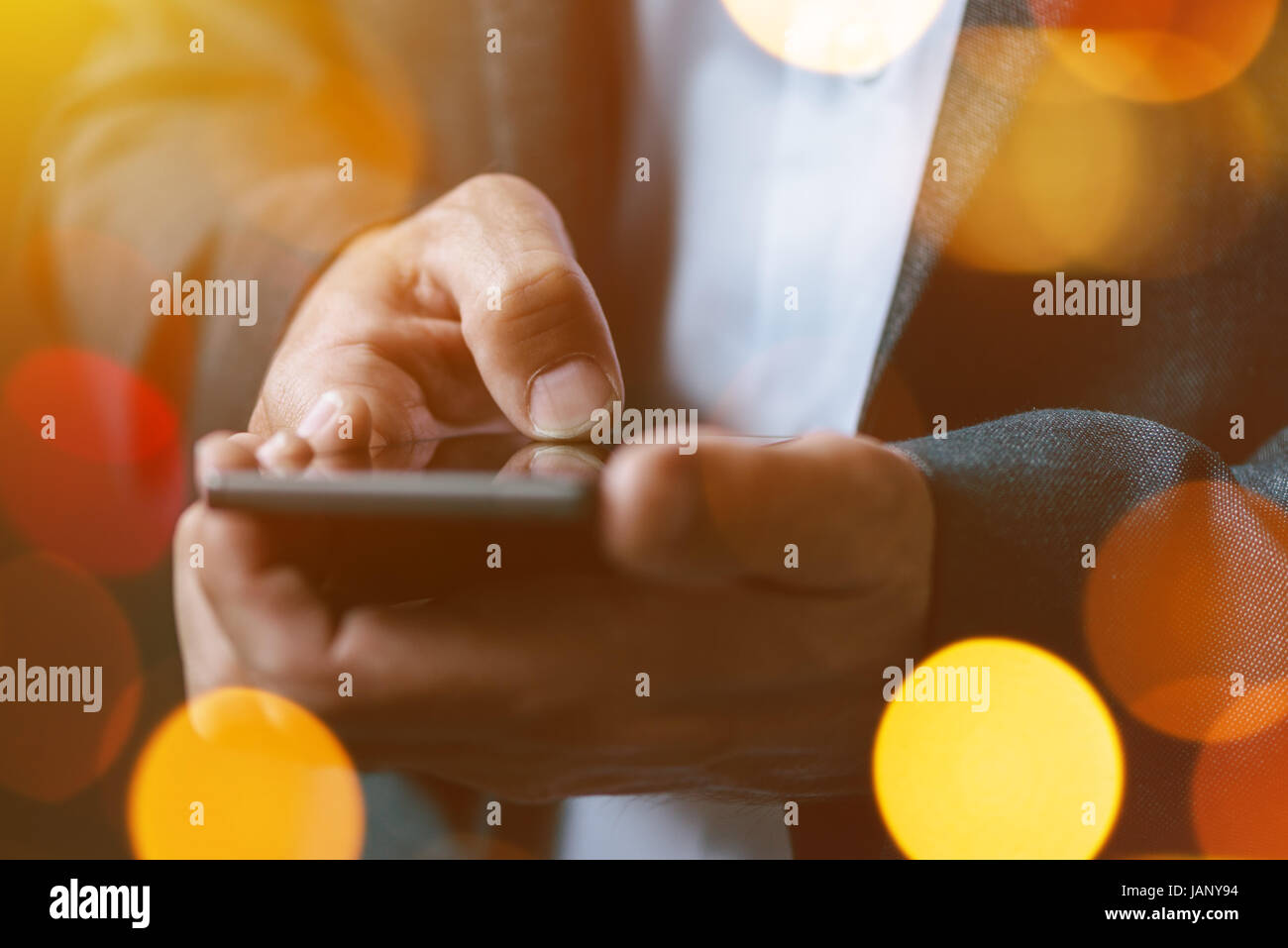 Businessman using mobile phone, close up of hand and thumb pushing ...