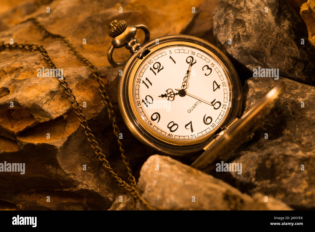 pocket watch with rock Stock Photo - Alamy