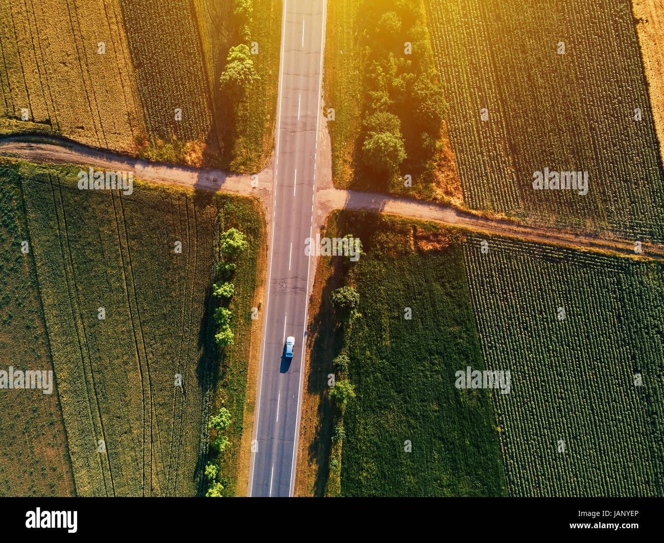 Aerial view of traffic on two lane road through countryside and ...