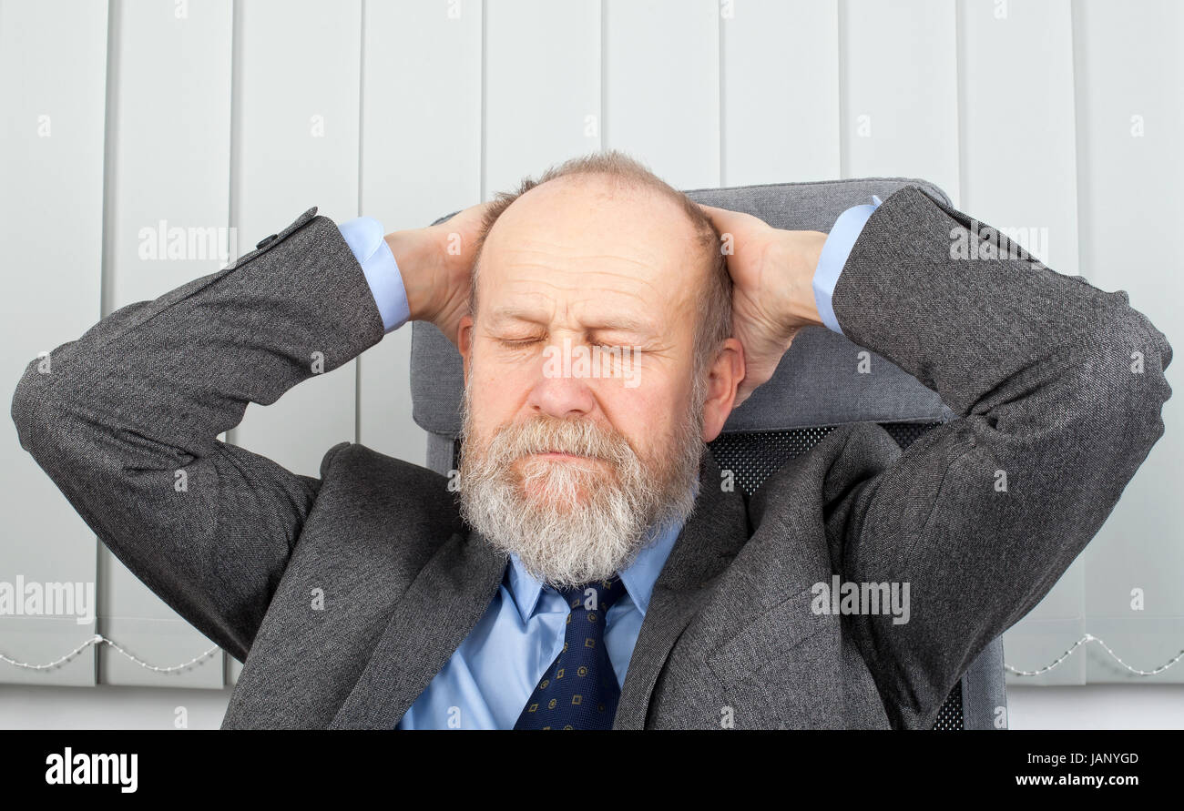 Picture of a tired businessman at his office Stock Photo - Alamy
