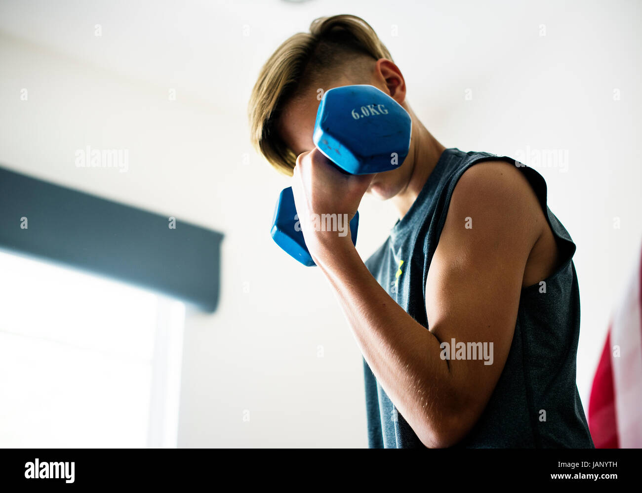 Young caucasian boy lifting dumbbell Stock Photo - Alamy
