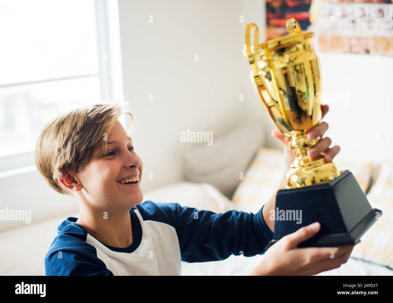 Young caucasian boy holding trophy cheerful happiness Stock Photo - Alamy