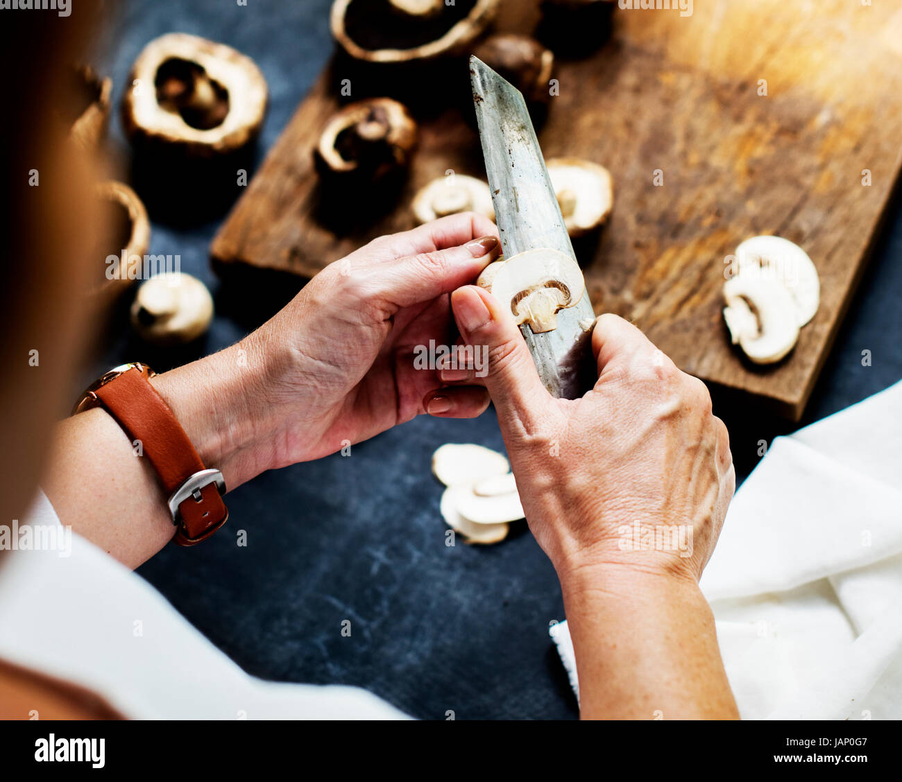 Closeup of hand with knife cutting mushroom Stock Photo - Alamy