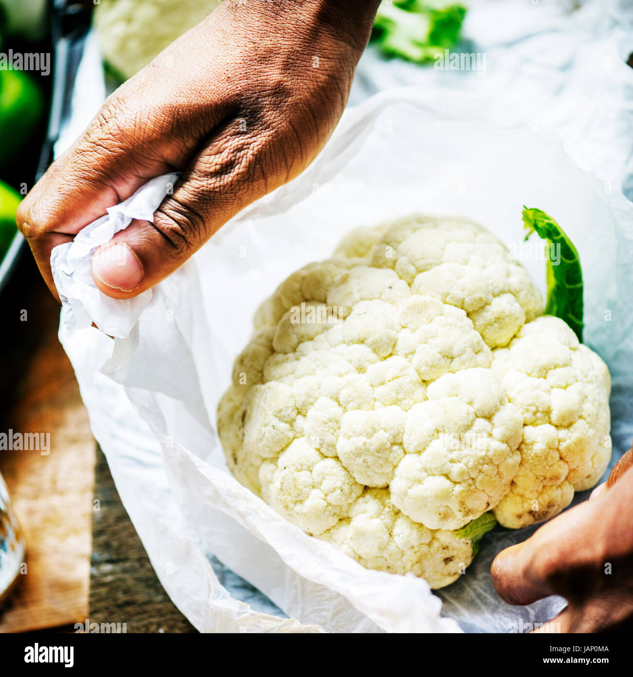 Closeup of hand with cauliflower in plastic bag Stock Photo - Alamy