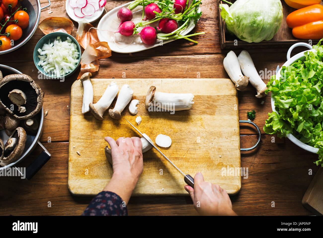 Aerial view of hand with knife cutting mushroom Stock Photo - Alamy