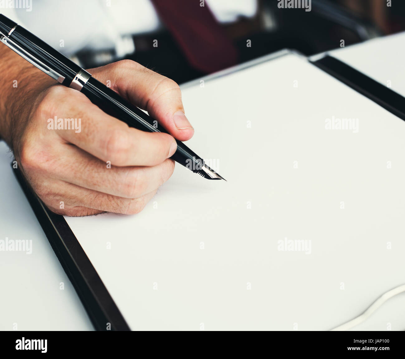 Closeup of hand with fountain pen over blank paper Stock Photo - Alamy