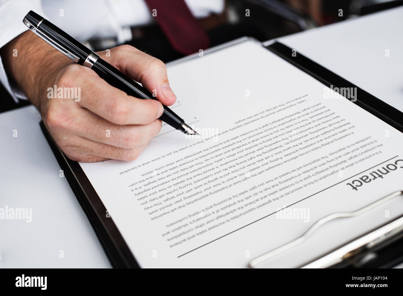 Closeup of hand signing paper workspace Stock Photo - Alamy