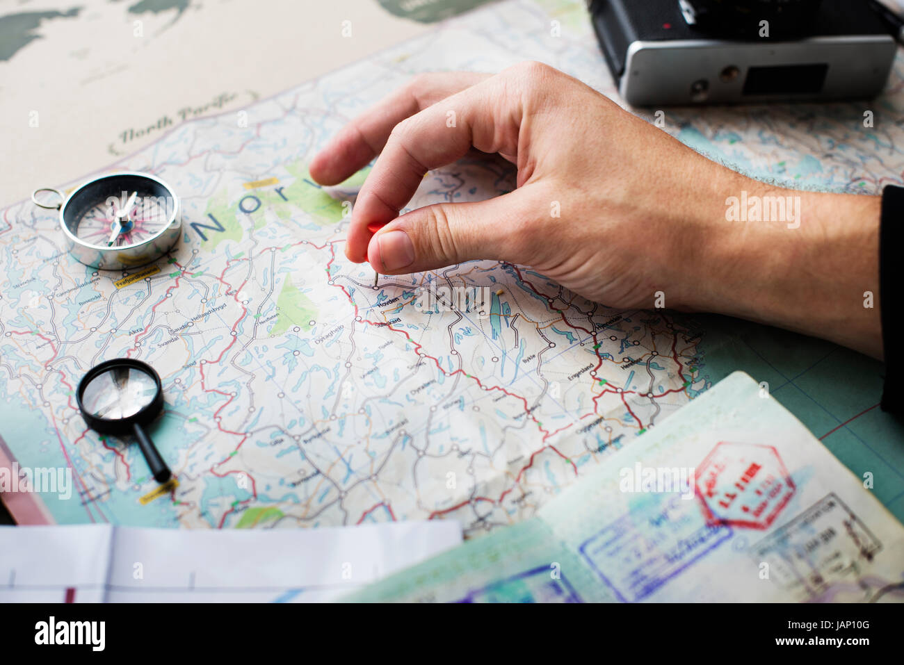 Closeup of hand pinning on world map journey travel Stock Photo - Alamy