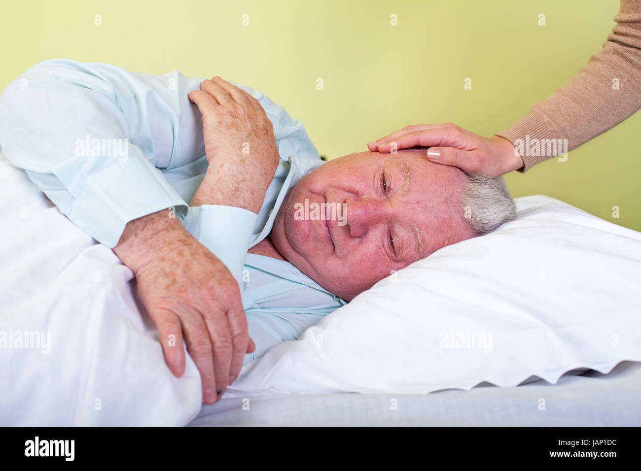 Picture of an agonized elderly man in bed Stock Photo - Alamy