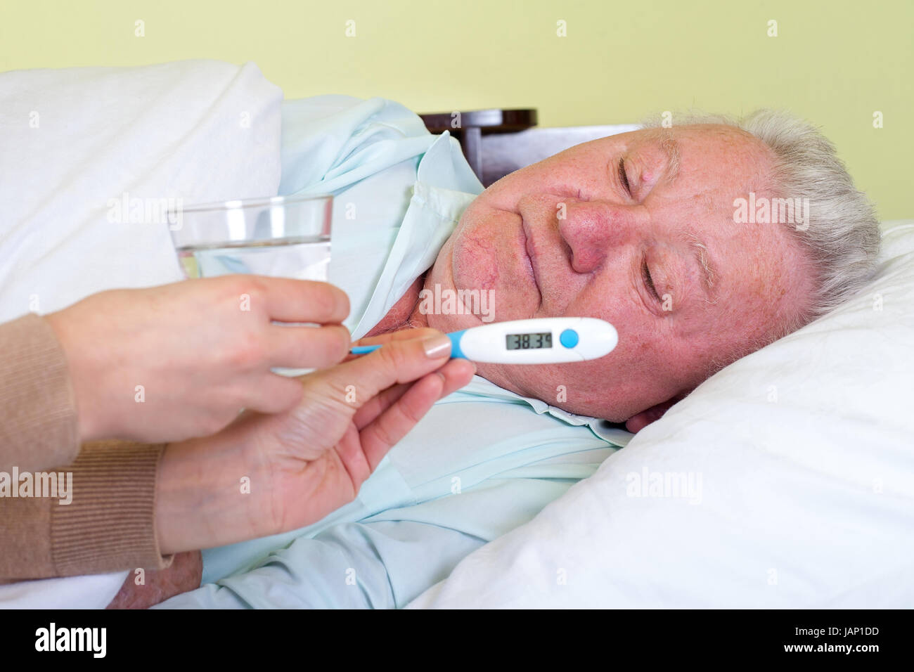Picture of a sick old man in bed having fever Stock Photo - Alamy