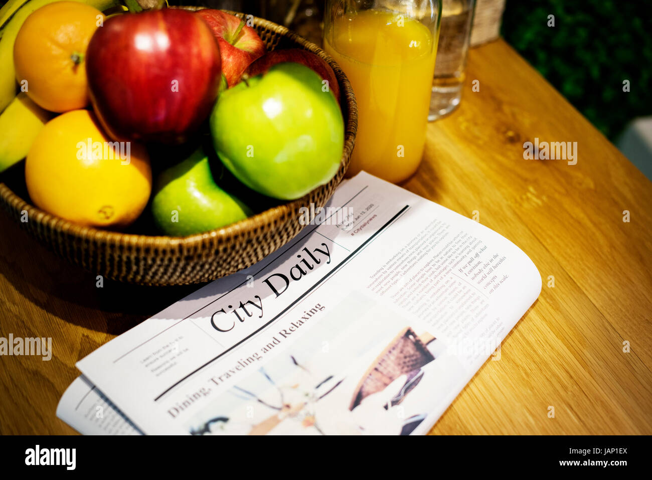 Closeup of fruits and newspaper on wooden table Stock Photo - Alamy