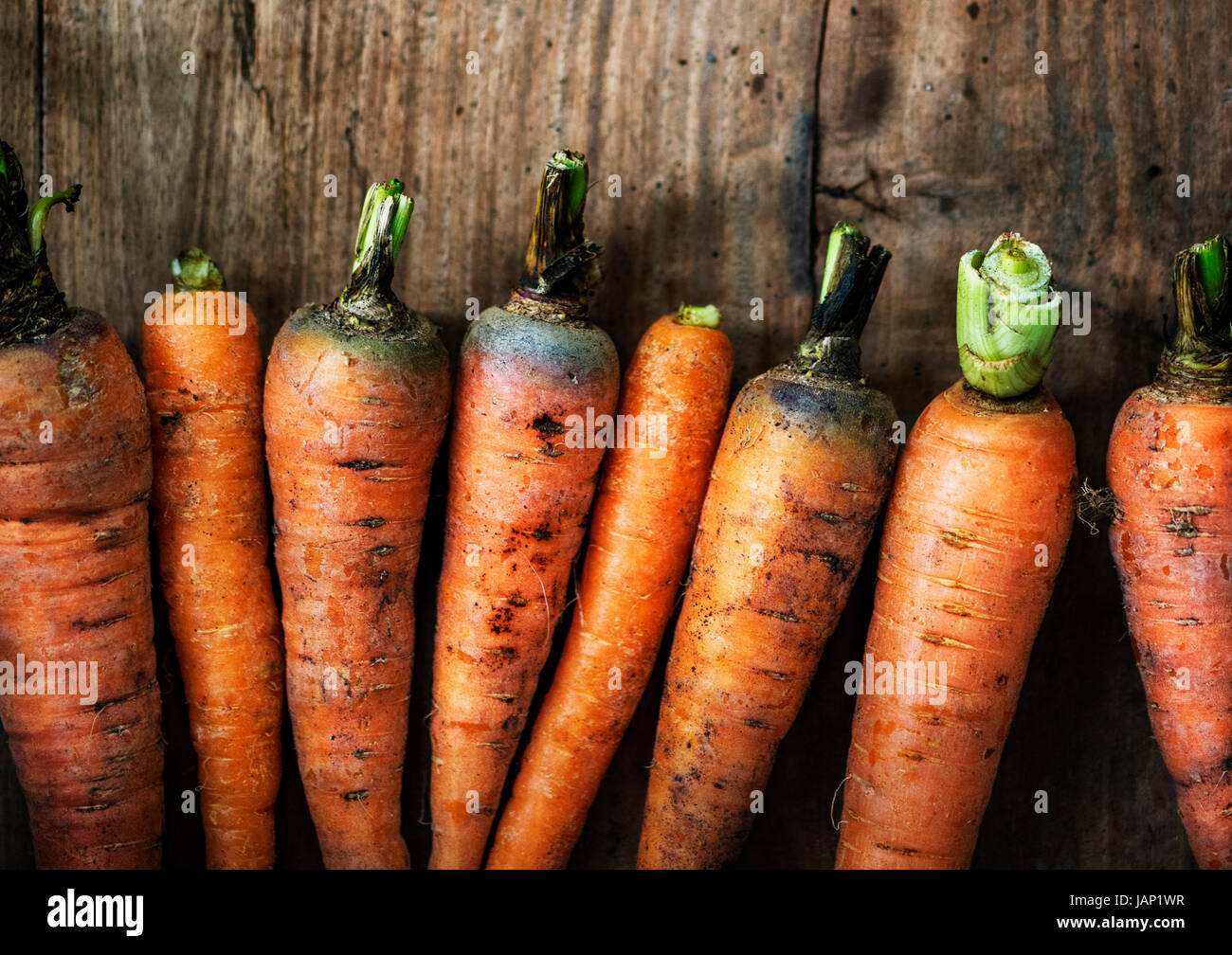 Aerial view of carrots on wooden background Stock Photo - Alamy