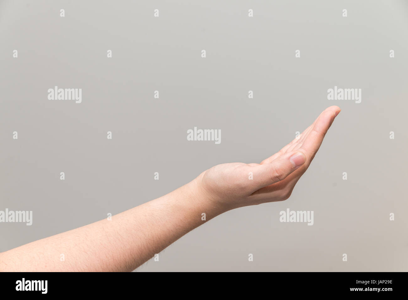 Human hand with open palm ready to recieve on light gray background ...