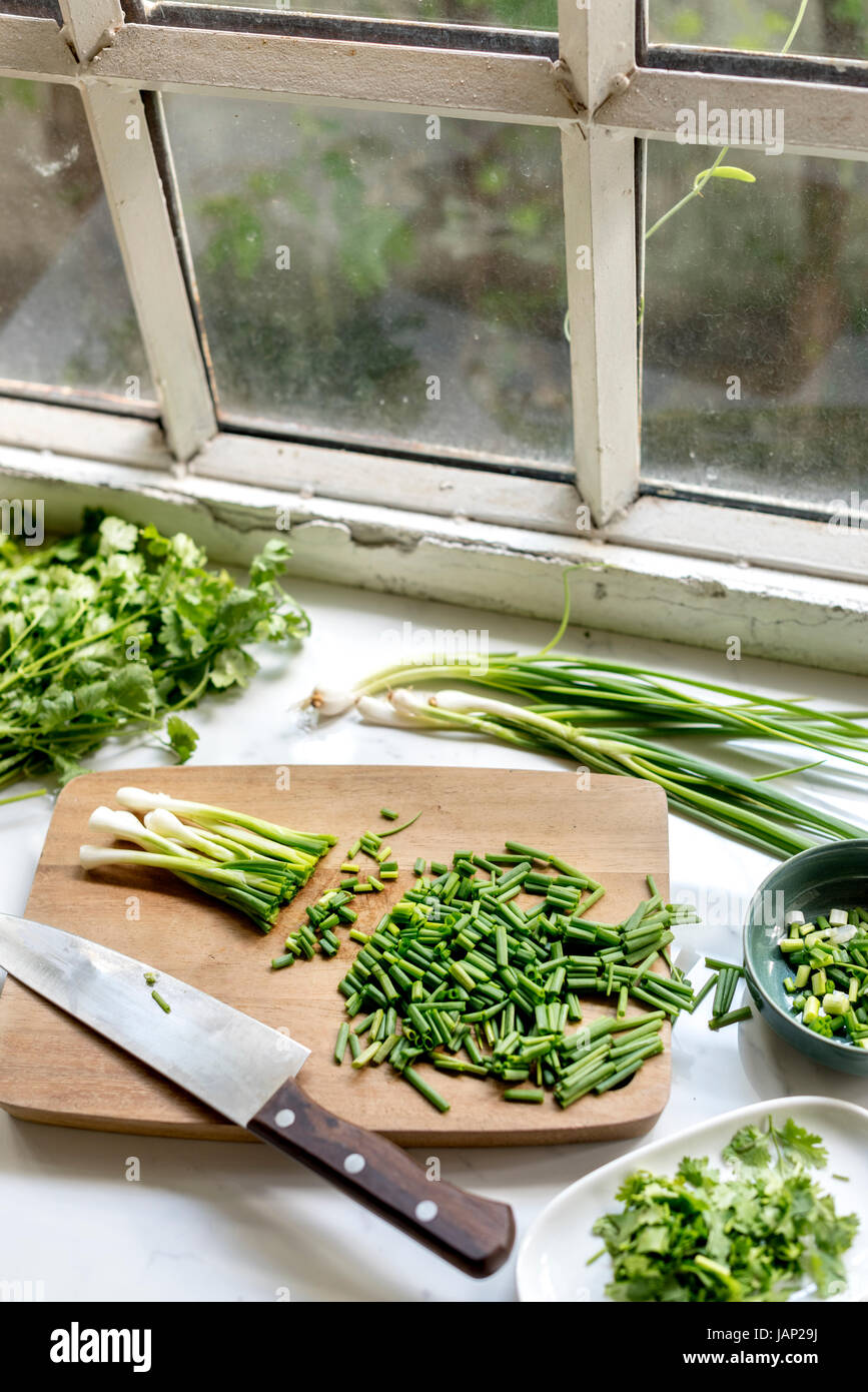 Closeup of knife with fresh cut organic spring onion Stock Photo - Alamy