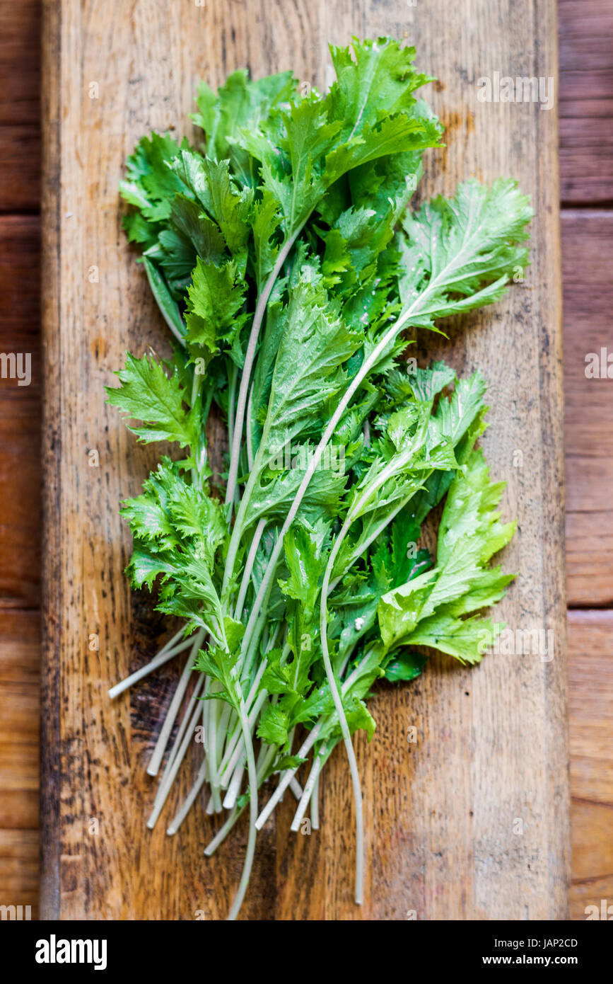 Aerial view of green organic leafy vegetable on wooden background Stock ...