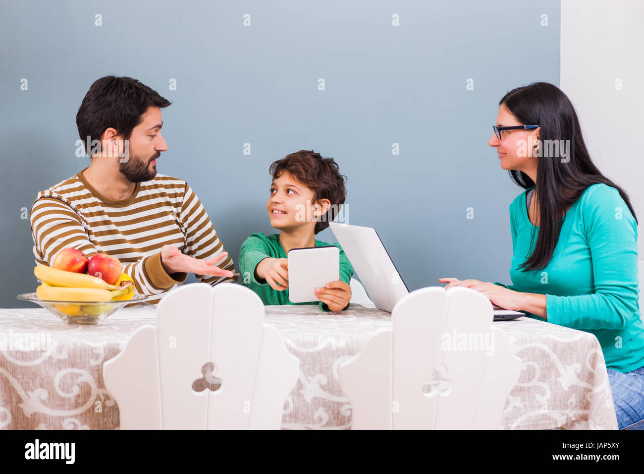 Parents are teaching their son to use computer Stock Photo - Alamy