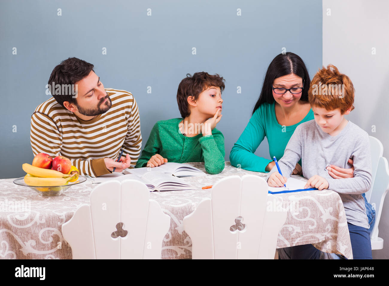 Parents are teaching their children at home Stock Photo - Alamy