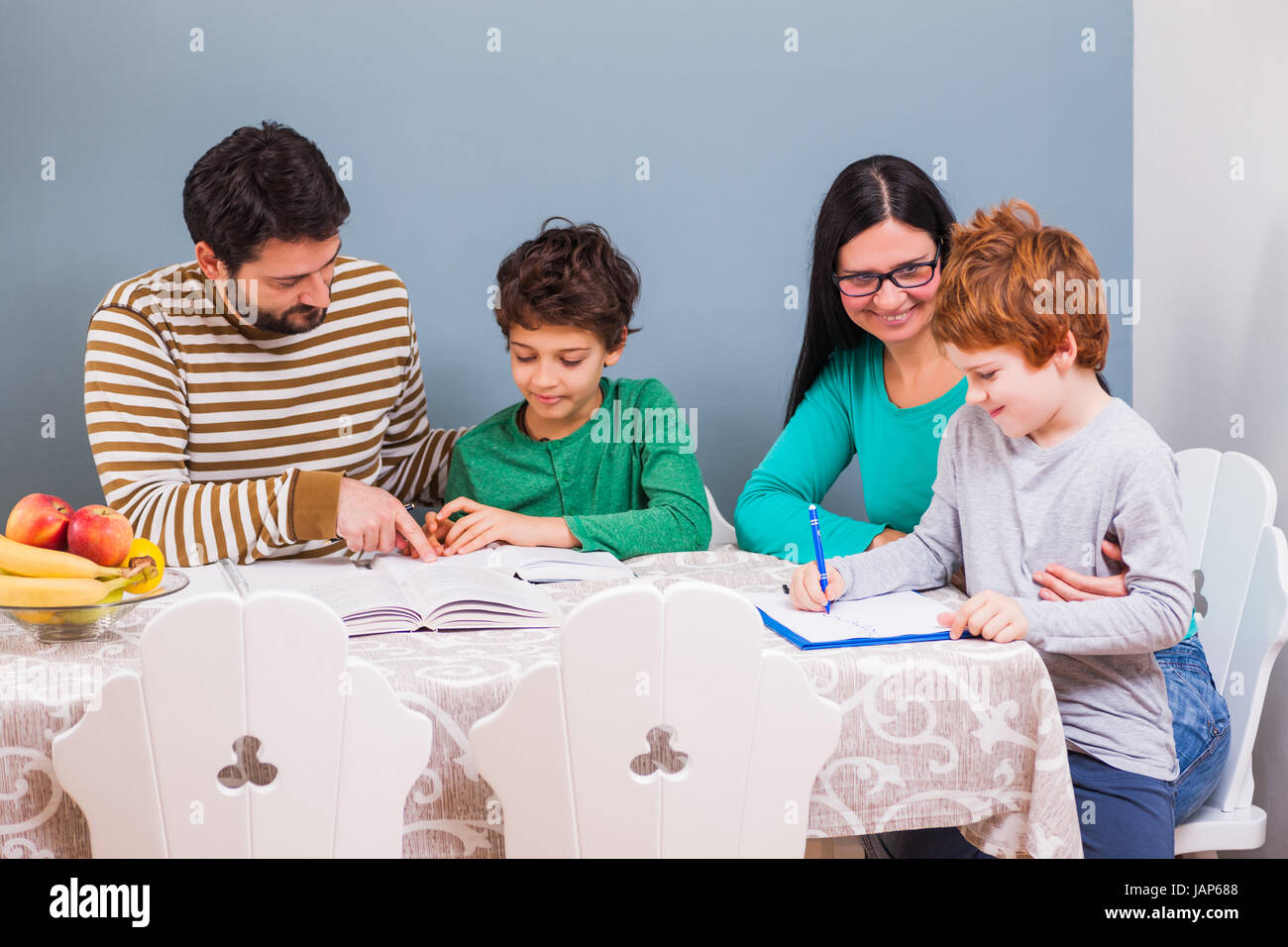 Parents are teaching their children at home Stock Photo - Alamy