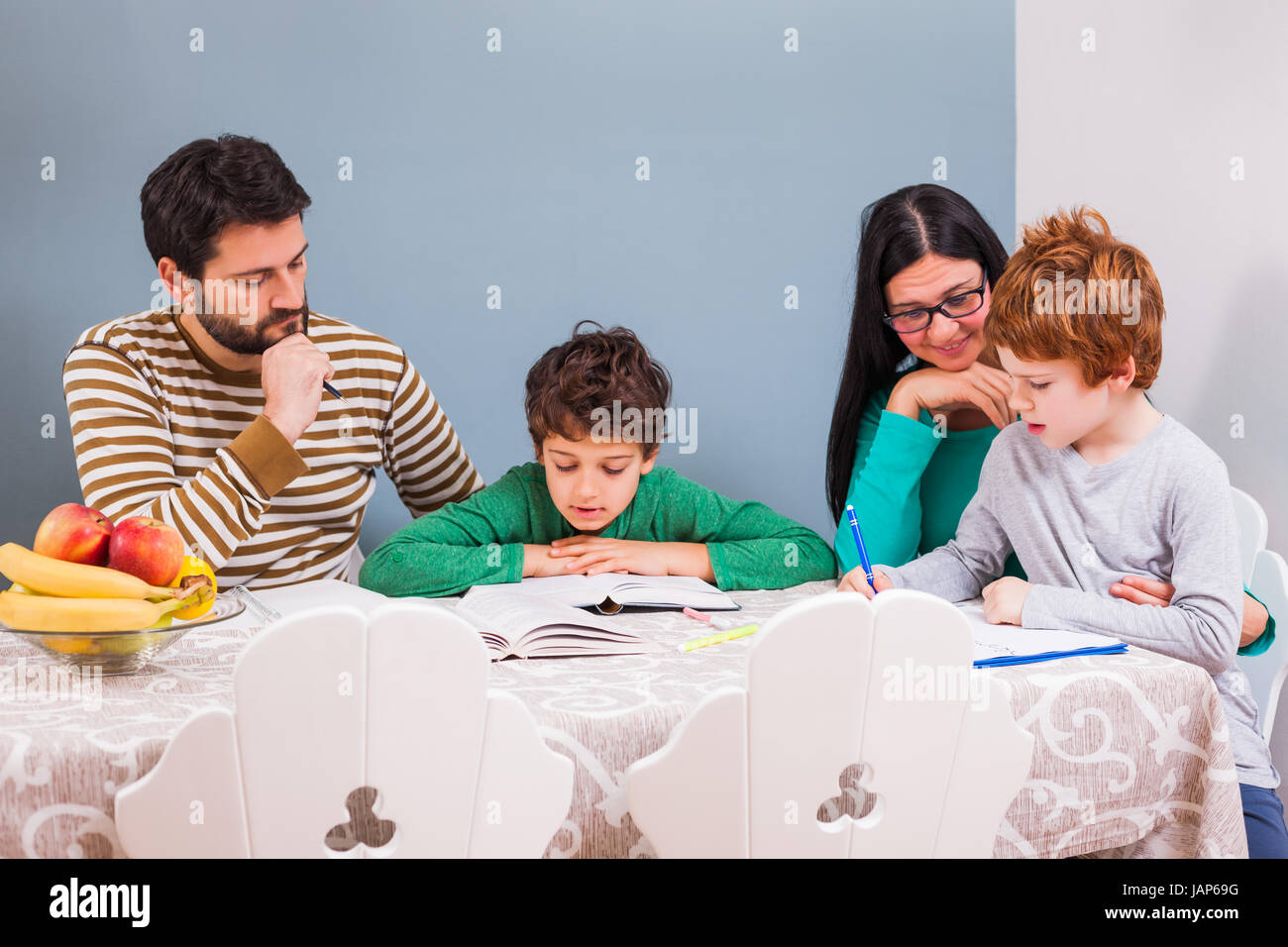 Parents are teaching their children at home Stock Photo - Alamy
