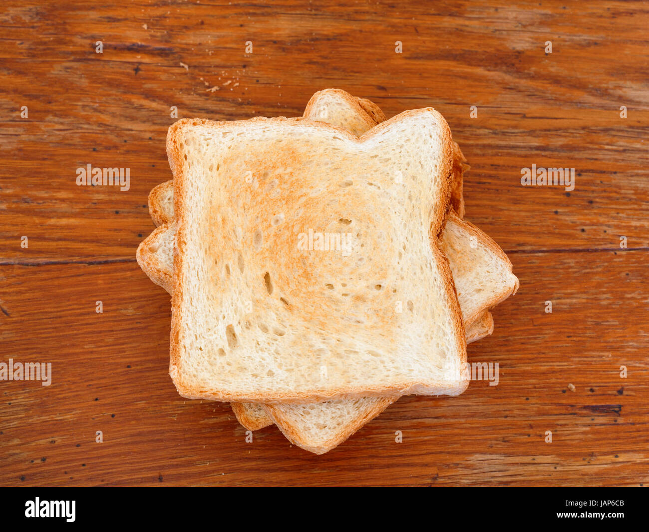 stack of freshly prepared toasts on wooden table Stock Photo - Alamy