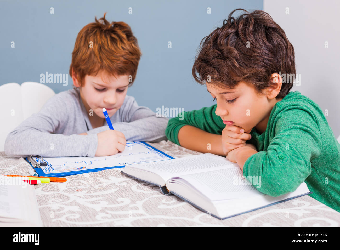 Brothers are doing homework together at home Stock Photo - Alamy