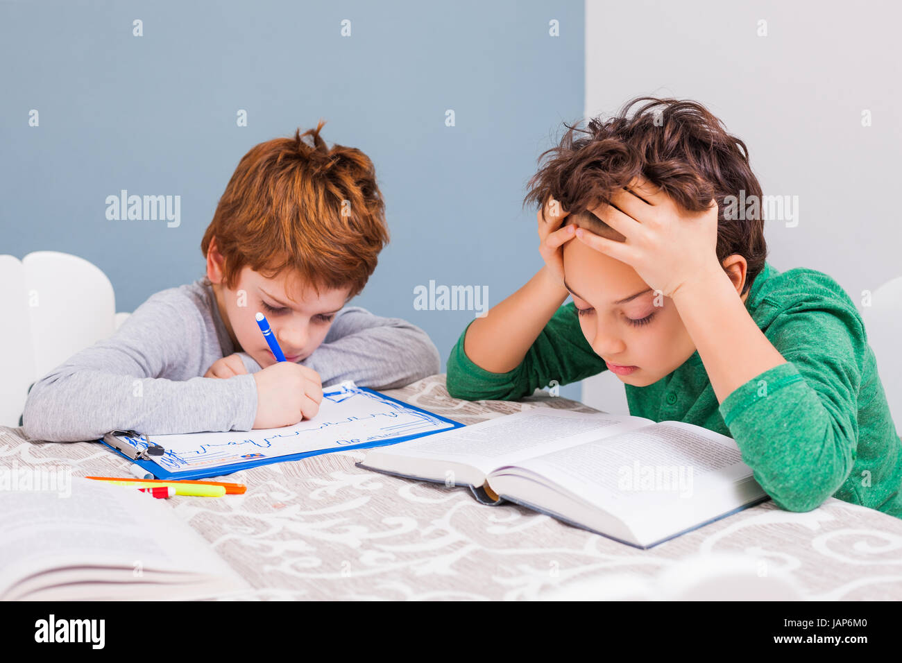 Brothers are doing homework together at home Stock Photo - Alamy