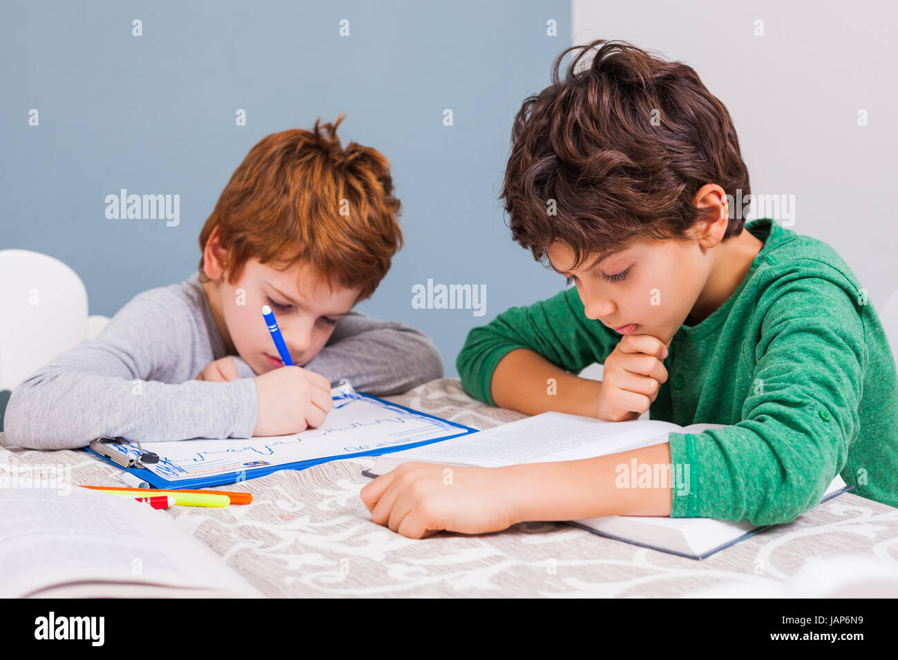 Brothers are doing homework together at home Stock Photo - Alamy