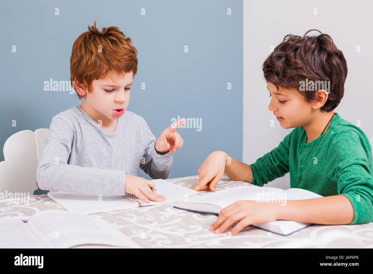 Brothers are doing homework together at home Stock Photo - Alamy