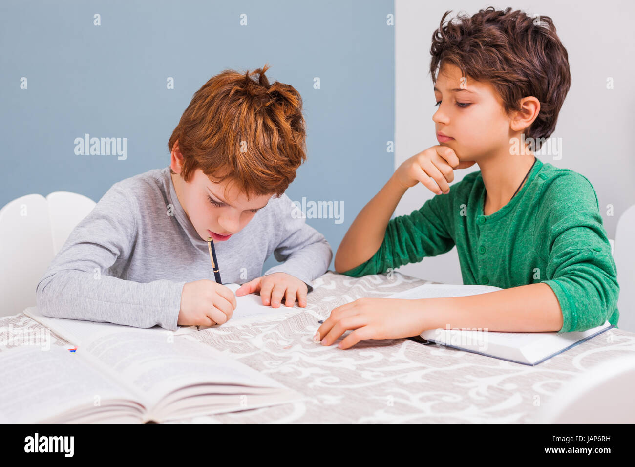 Brothers doing homework together hi-res stock photography and images ...
