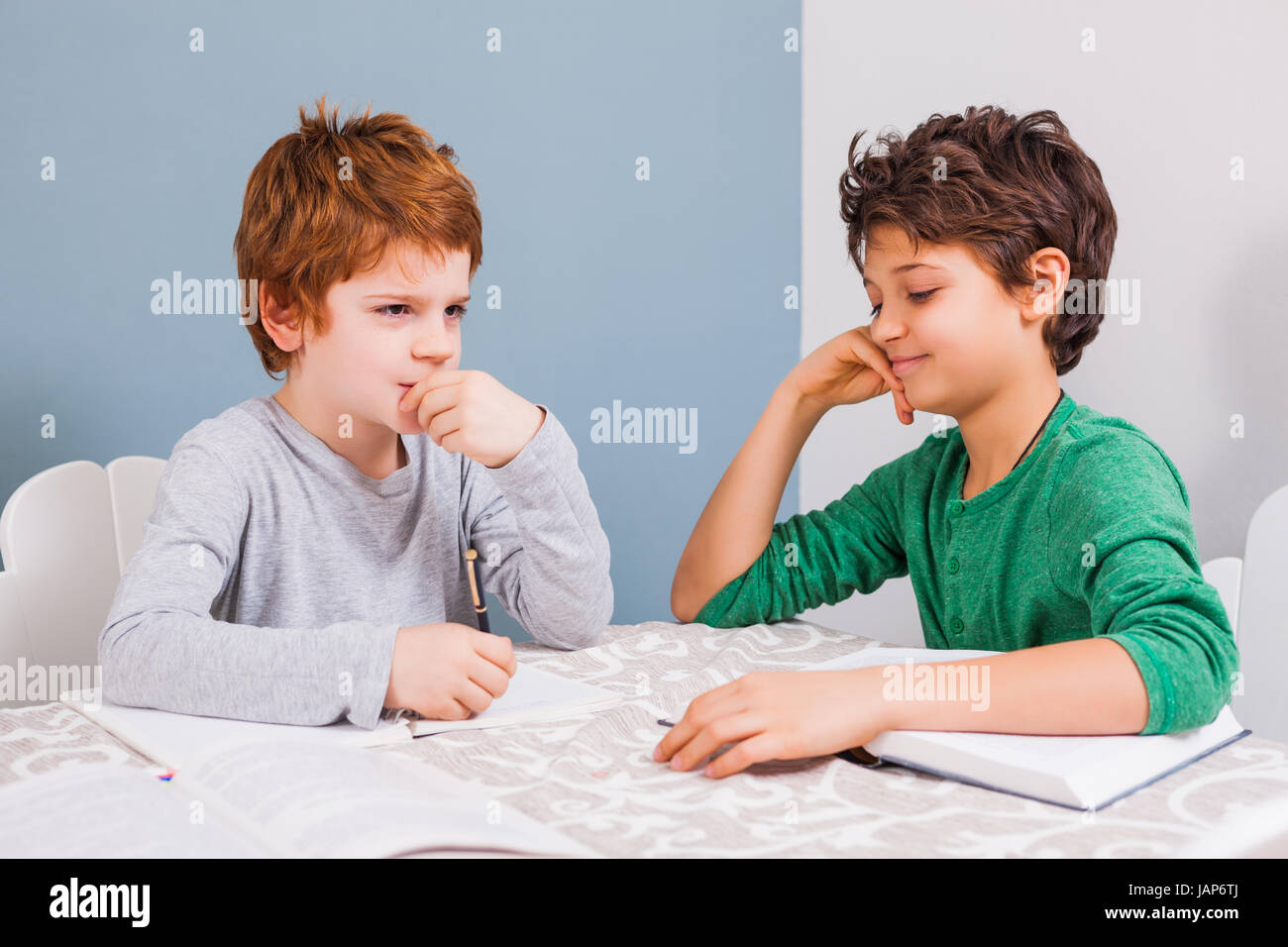 Brothers are doing homework together at home Stock Photo - Alamy