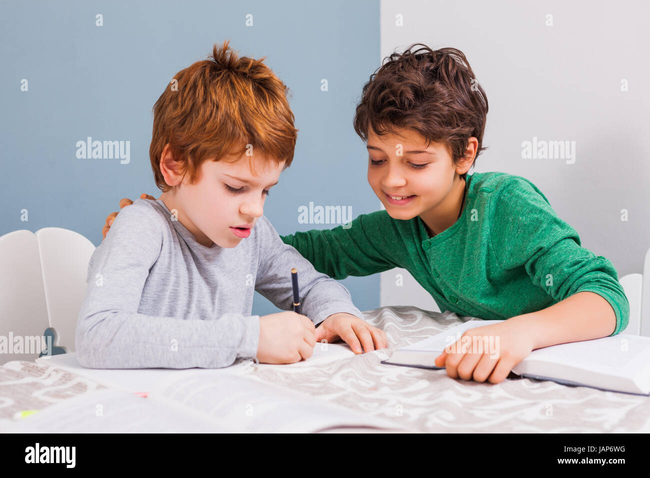 Brothers are doing homework together at home Stock Photo - Alamy
