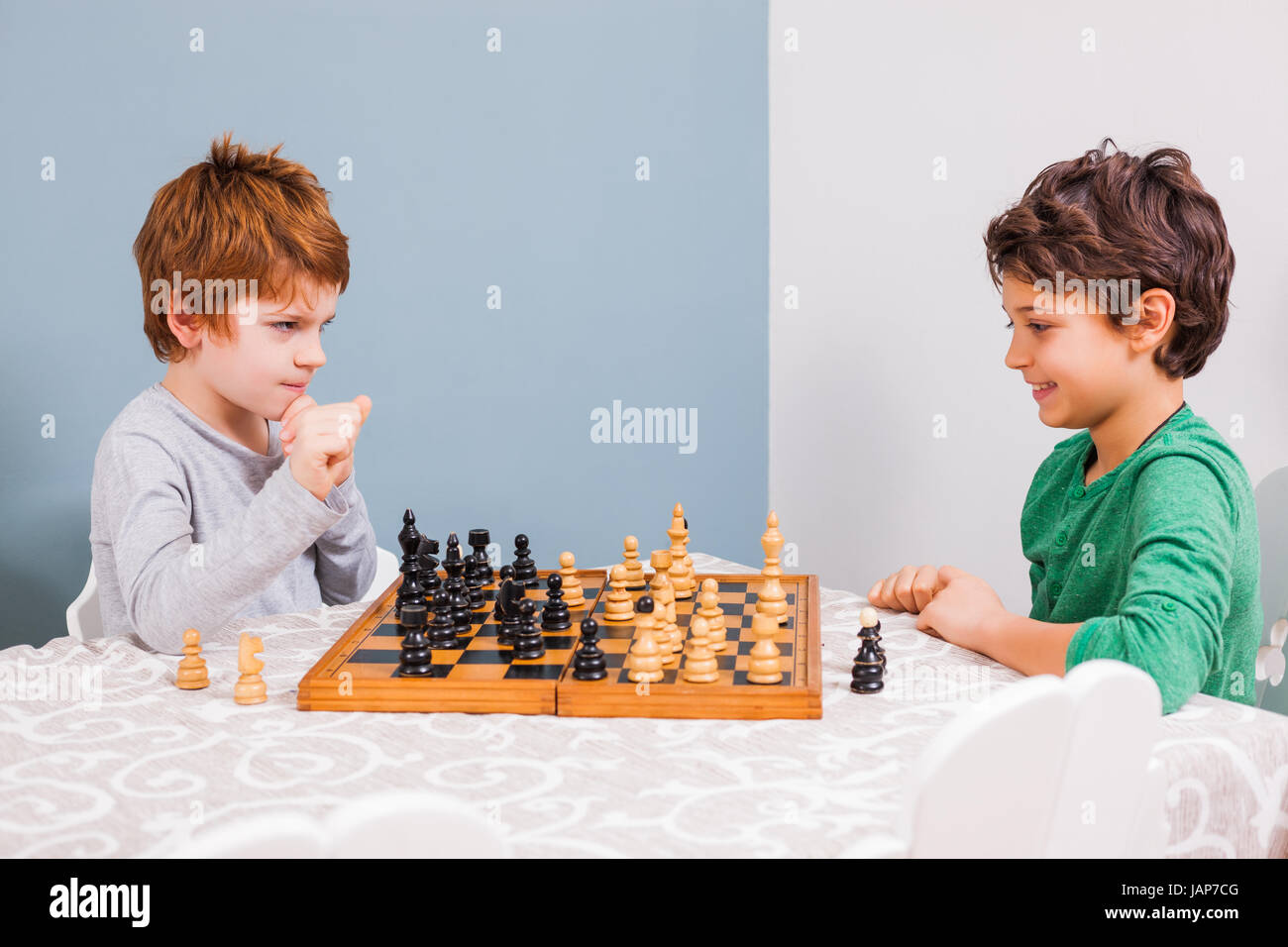 Two brothers are playing chess at home Stock Photo - Alamy