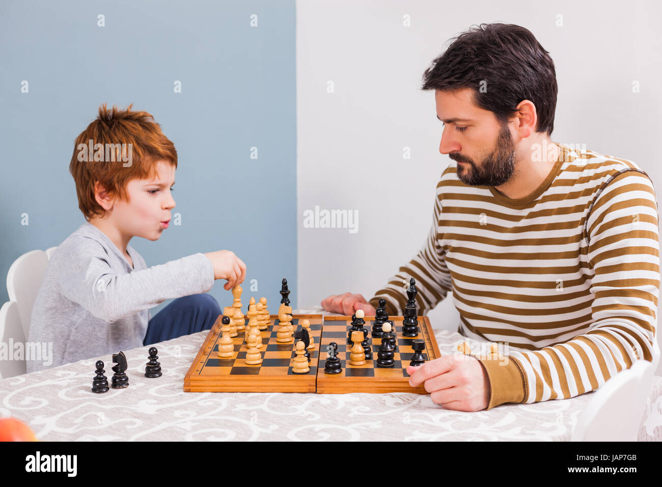 Father and son are playing chess at home Stock Photo - Alamy
