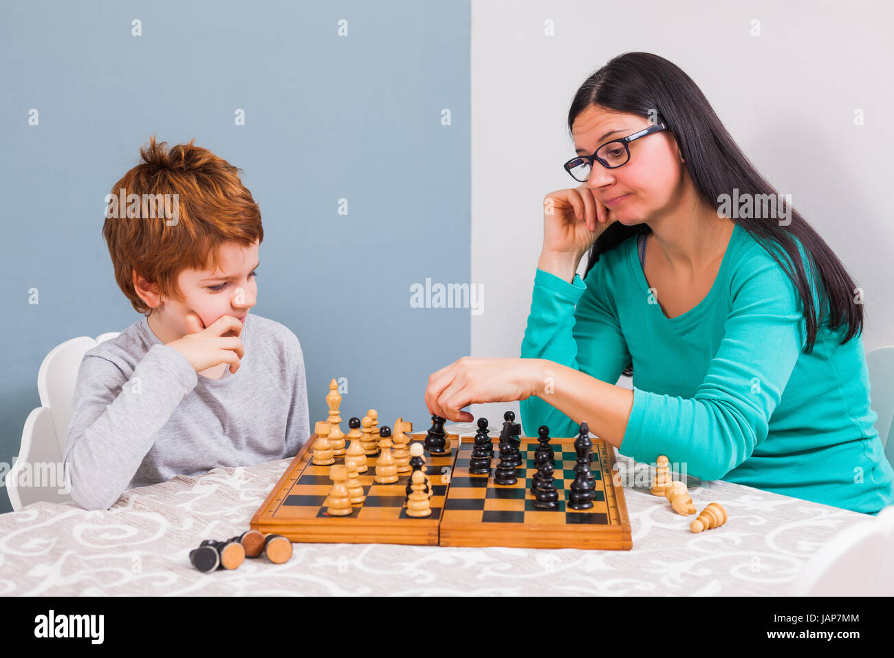 Mother and her son are playing chess at home Stock Photo - Alamy