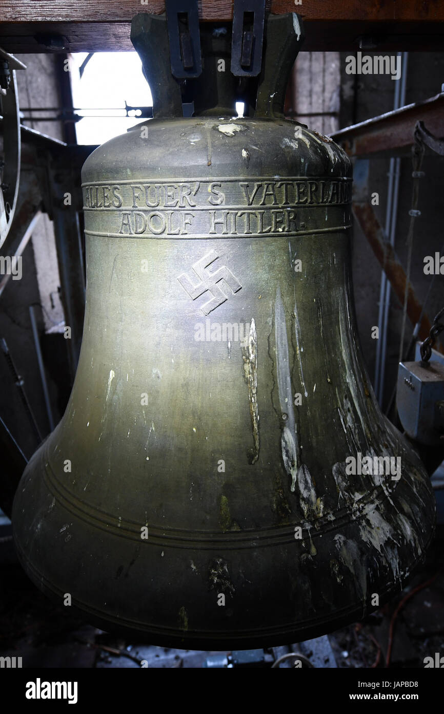 A bronze church bell featuring a swastika and the slogan 'Everything ...