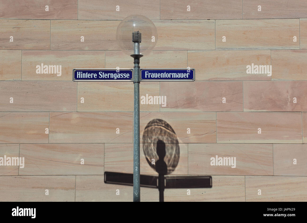 Nuremberg, sign post in the old city with a lantern, post showing the ...