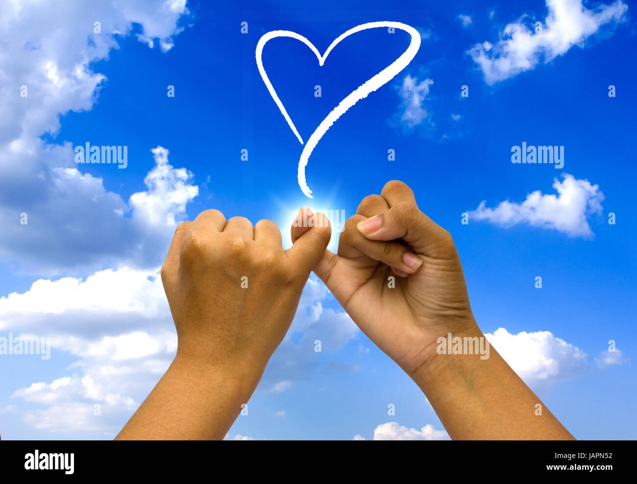 Two coupled hands on blue sky Stock Photo - Alamy