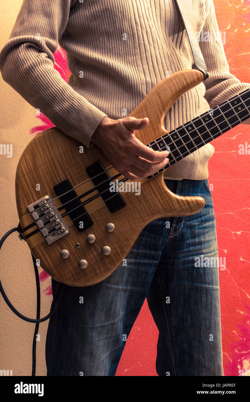 Young Man playing a bass guitar (Series with the same model available ...