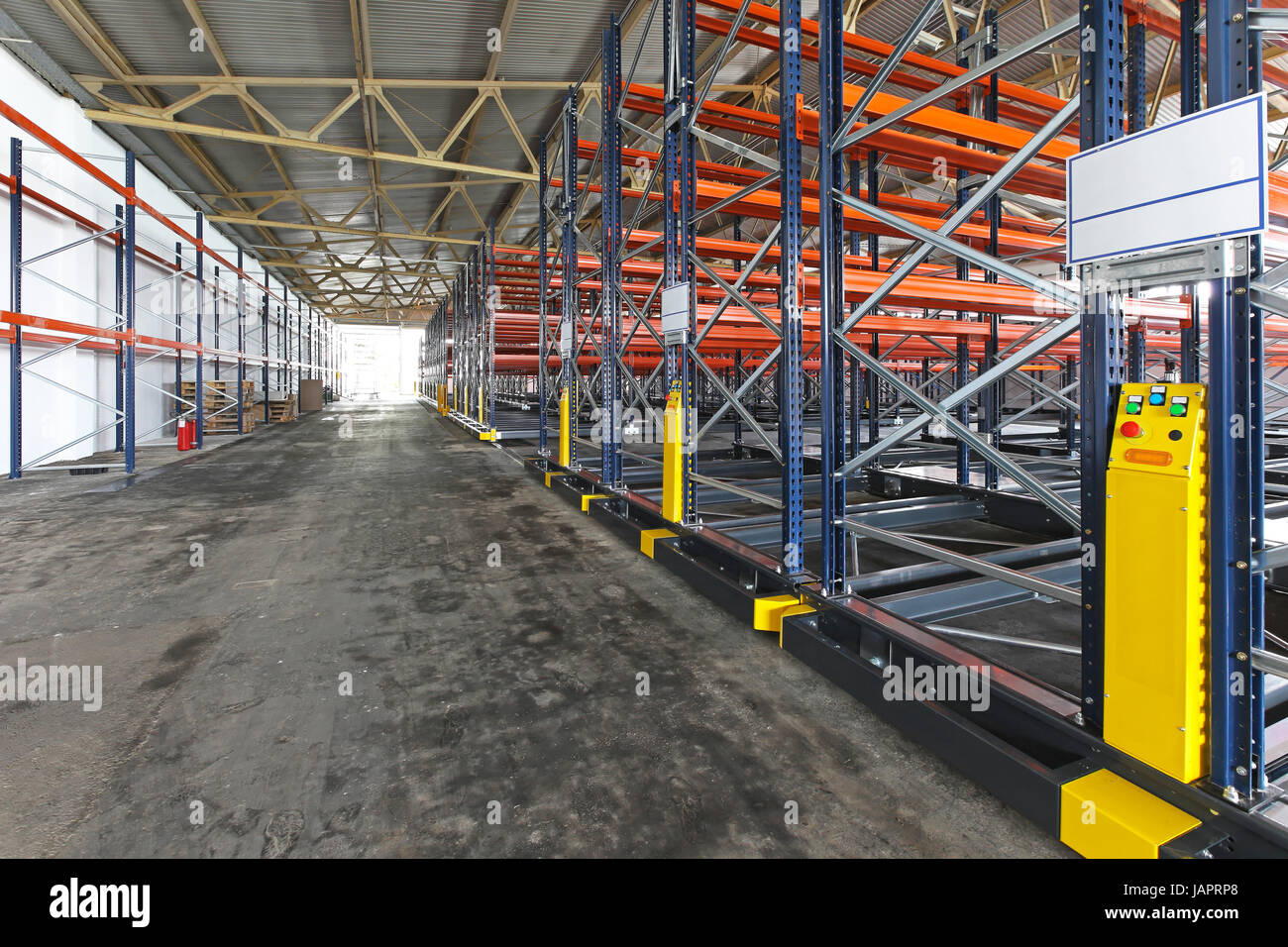 Powered mobile shelving system in distribution warehouse Stock Photo ...