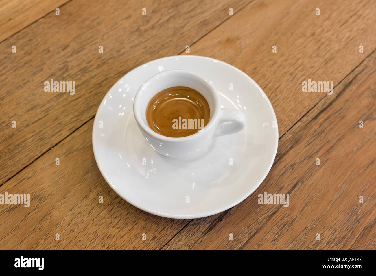 Coffee in white cup on wood table Stock Photo - Alamy