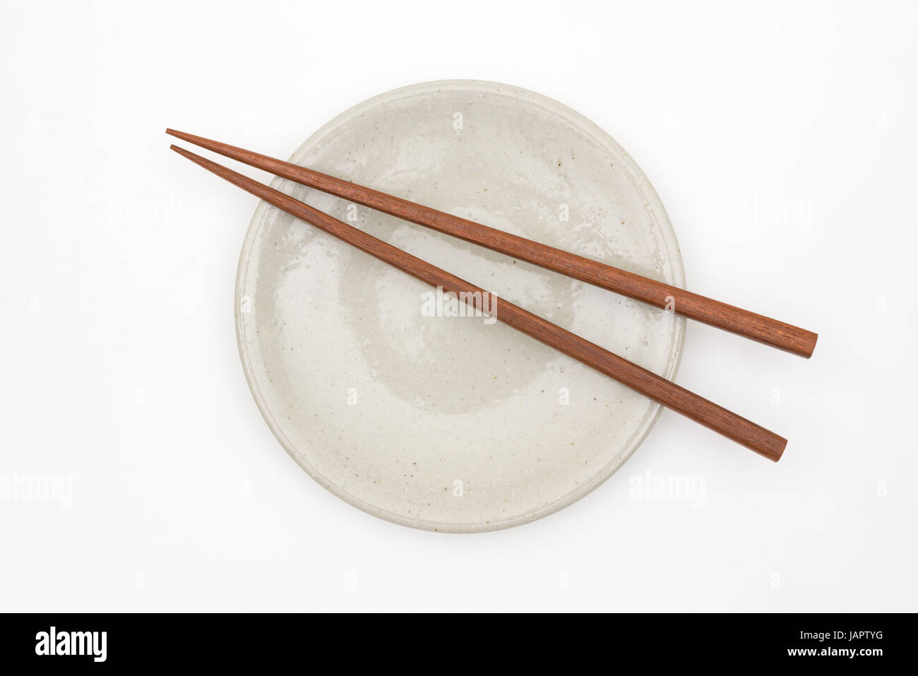 Traditional Japanese wooden chopstick on white ceramic plate Stock ...