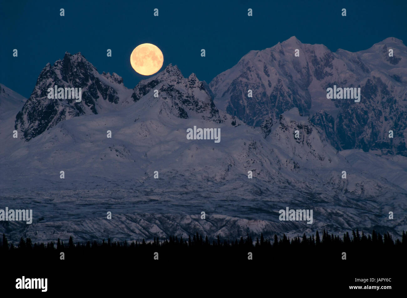 Moon rises over the land of the midnight sun Stock Photo - Alamy