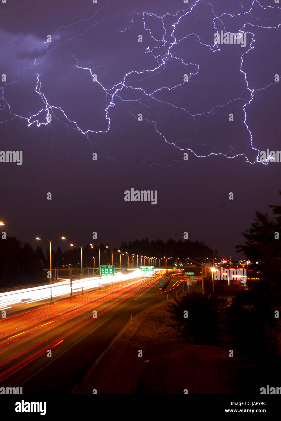 Batch of lightning over a busy highway at night Stock Photo - Alamy