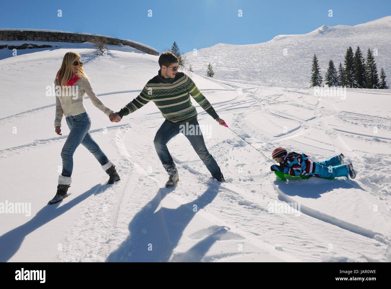 Winter season. Happy family having fun on fresh snow on vacation Stock ...