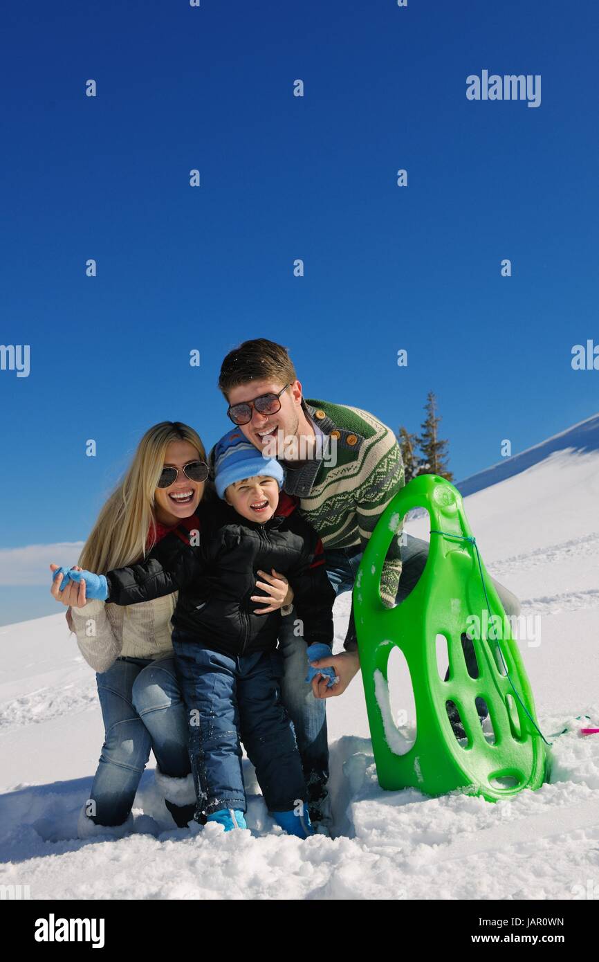 Winter season. Happy family having fun on fresh snow on vacation Stock ...