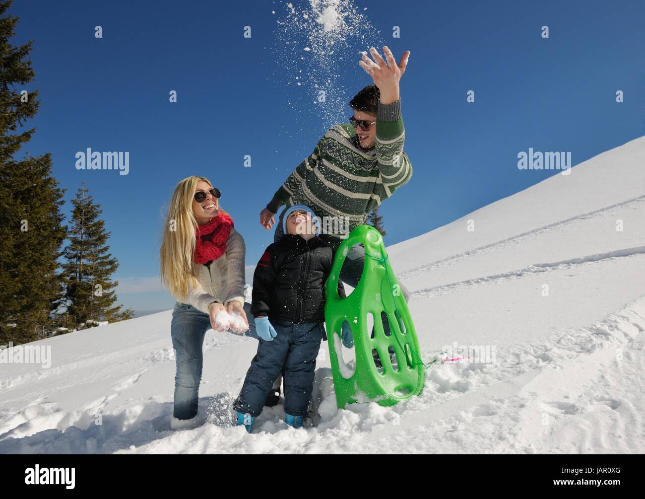 Winter season. Happy family having fun on fresh snow on vacation Stock ...
