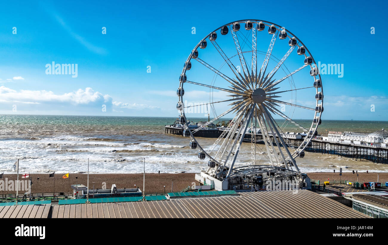 View of the Victorian Brighton Pier and the Brighton wheel in a windi ...