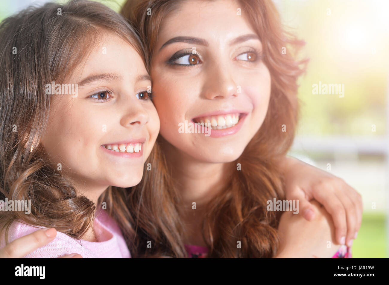 Beautiful young mother hugging her cute little daughter Stock Photo - Alamy