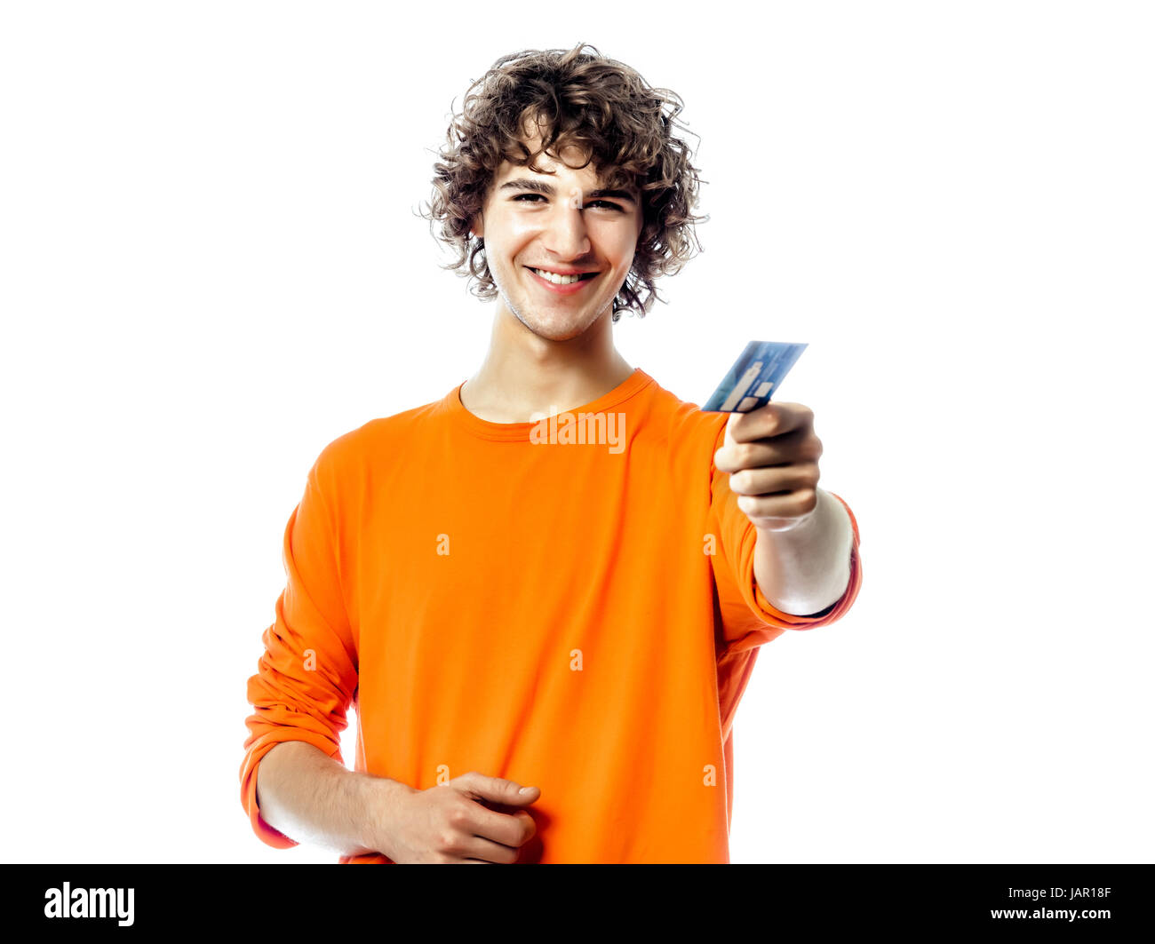 one young man caucasian happy holding credit card portrait in studio ...