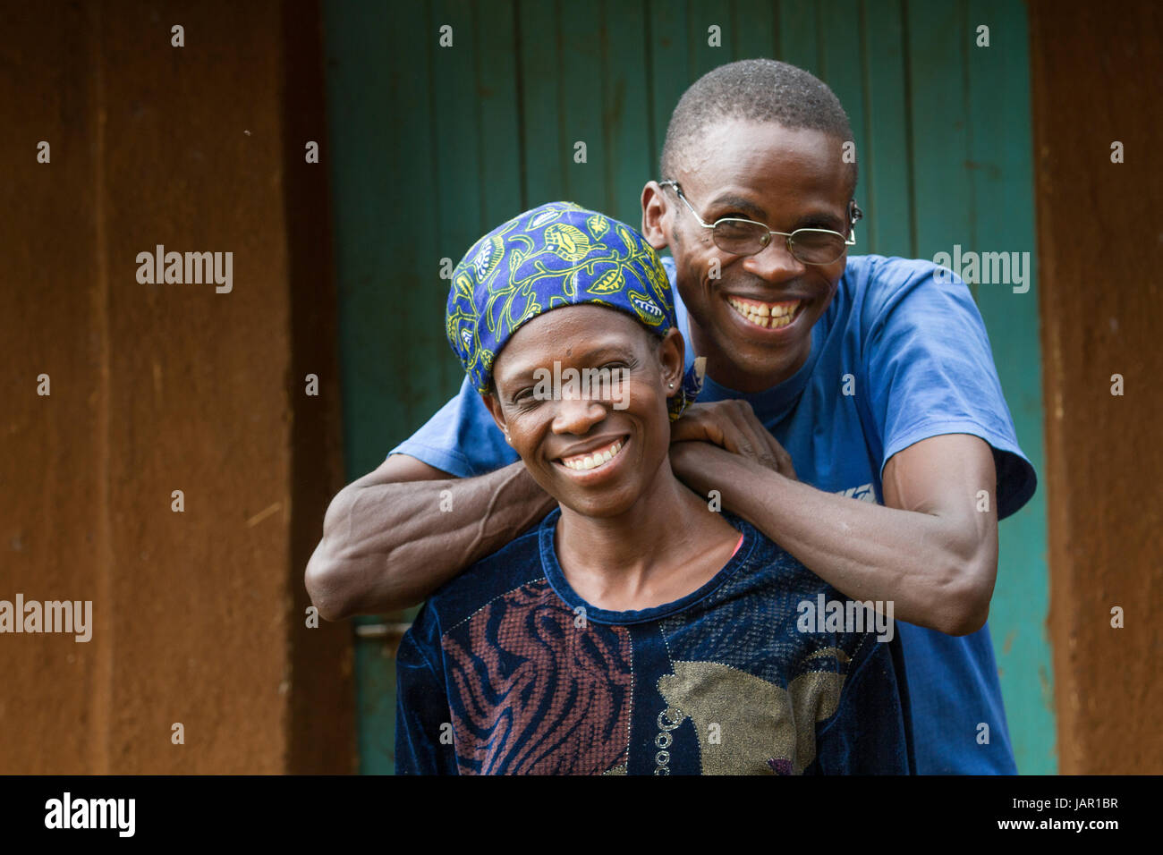 A man and woman pose for the camera outside their house, Kenya, Africa ...